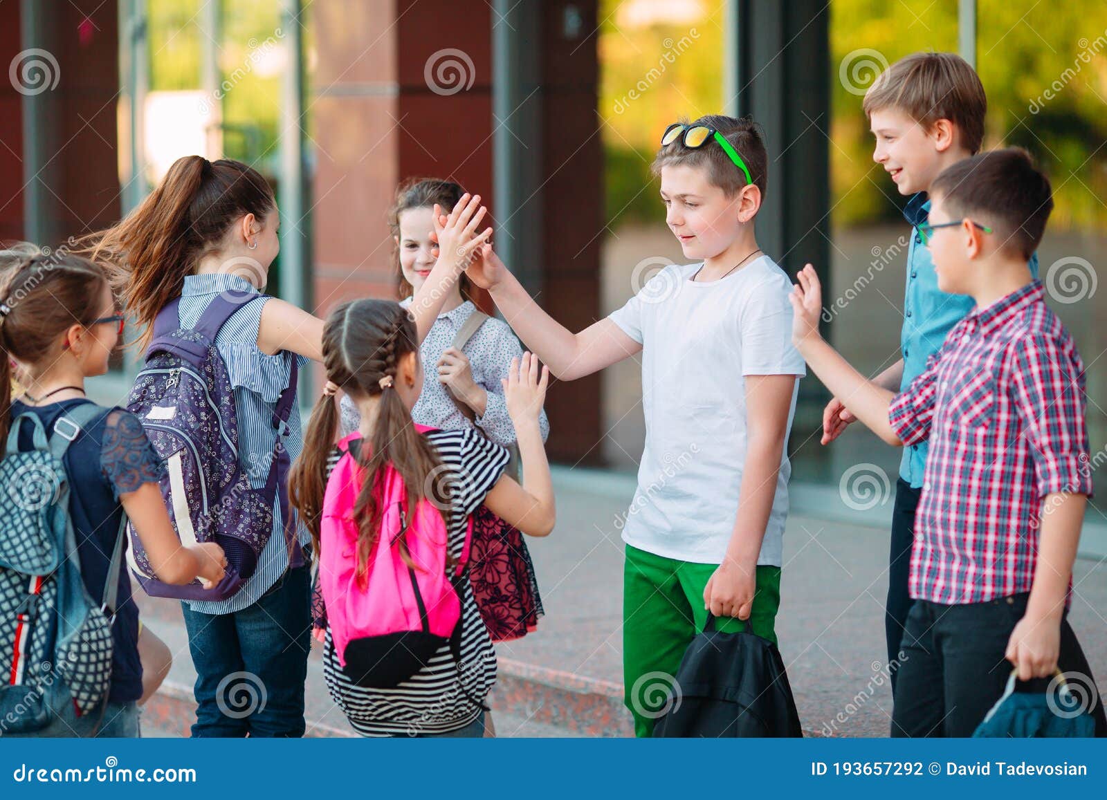 Schoolmates Go To School. Students Greet Each Other. Stock Photo ...