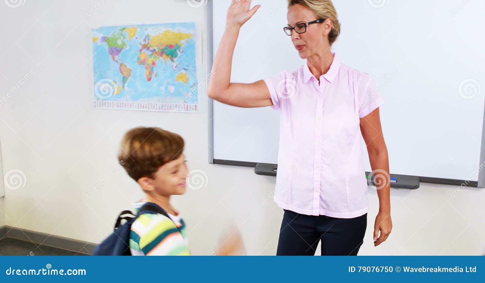 Schoolteacher and Kids Giving High Five in Classroom Stock Footage ...