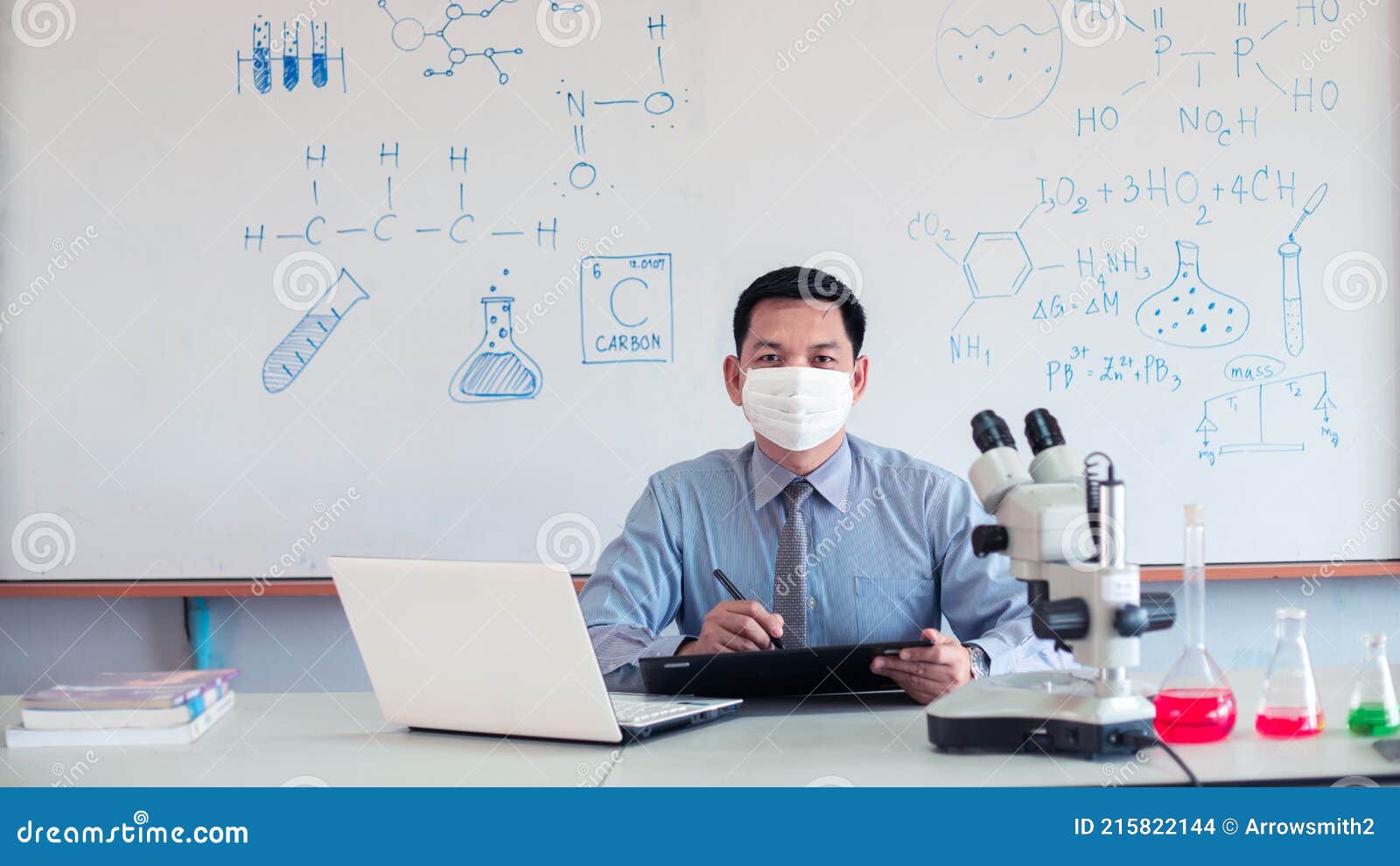 Science Chemistry Teacher Teaching with Microscope and Laptop in the ...