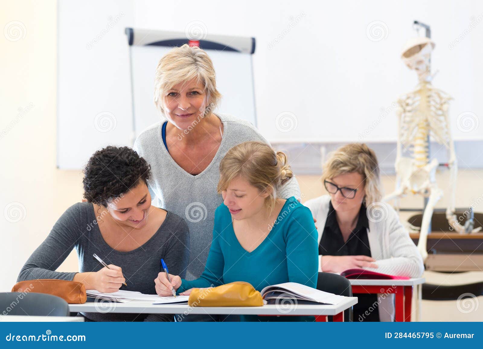 Science Class with Teacher and Three Female Students Stock Image ...