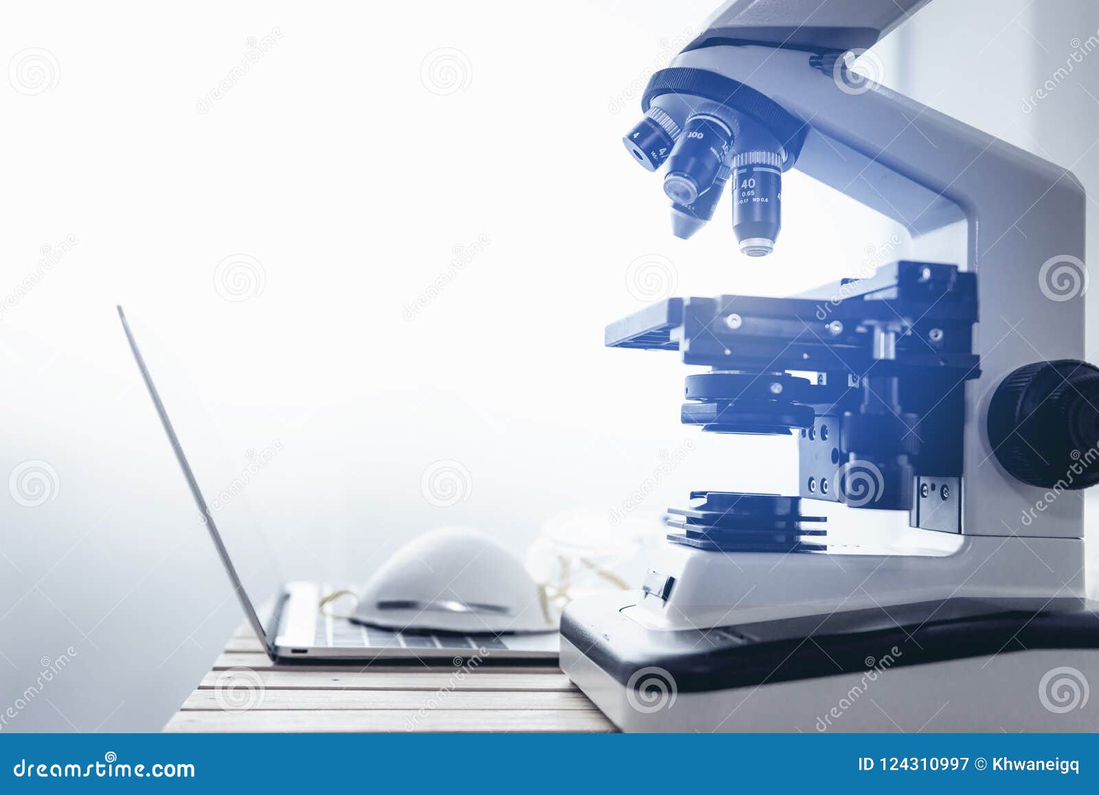 Scientist At Workspace In Laboratory With Microscope, Computer, And ...