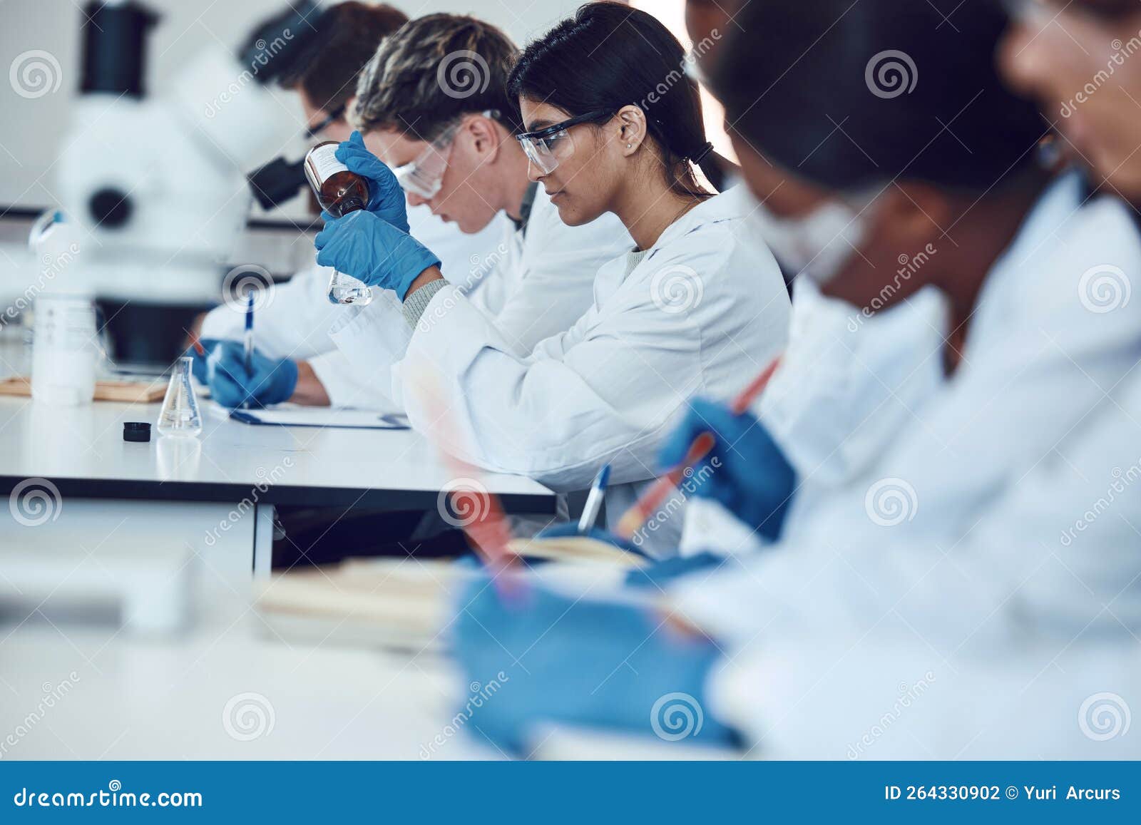 Scientist And Students Working In Lab. Doctor Teaching Interns To Make ...