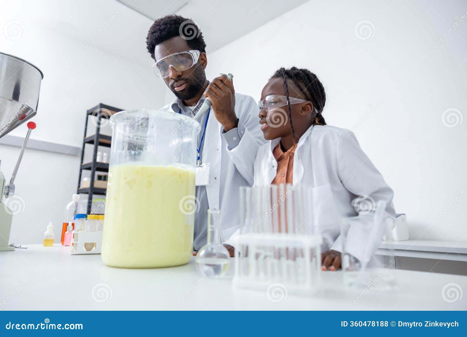 Teacher and Student Working in a School Laboratory and Looking Involved ...