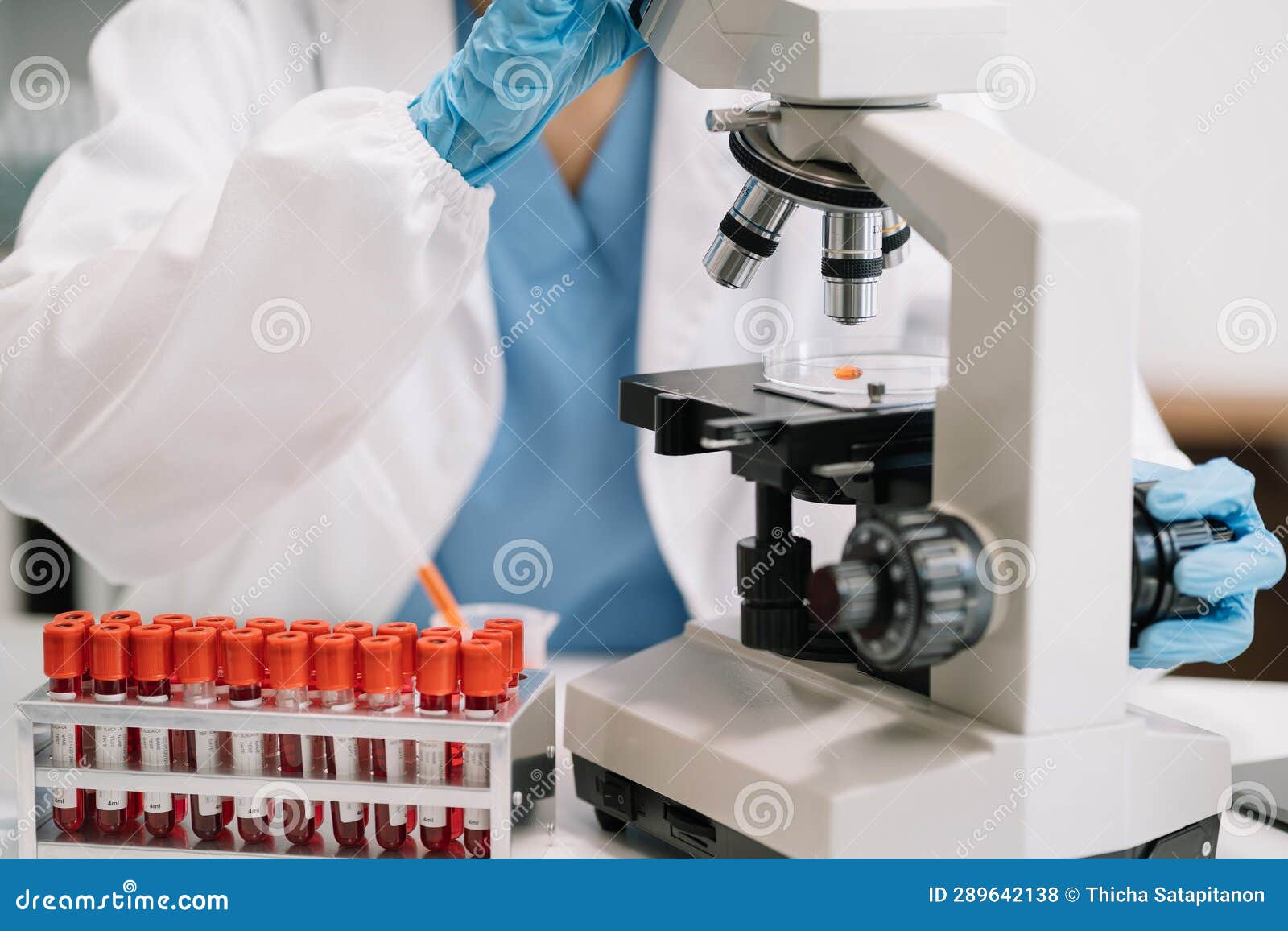 Science and Medicine, Scientist Analyzing and Dropping a Sample into a ...