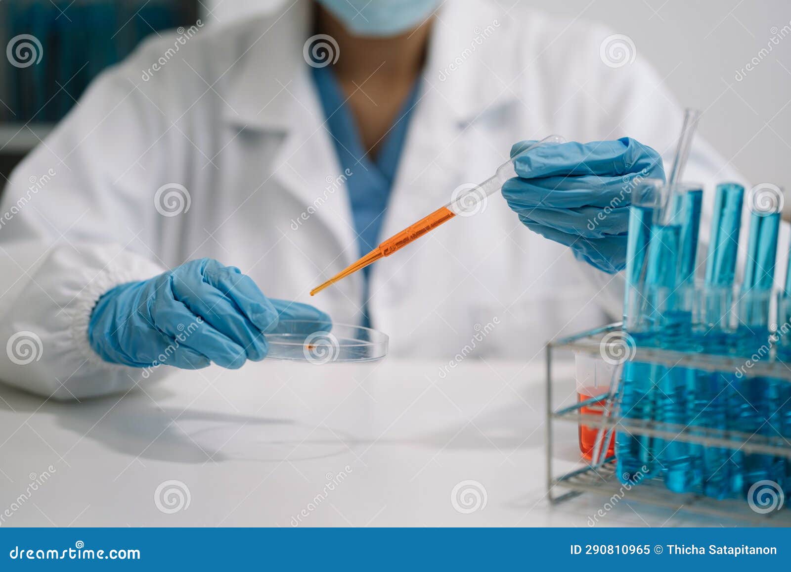 Science and Medicine, Scientist Analyzing and Dropping a Sample into a ...
