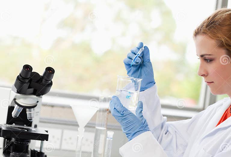 Science Student Dropping Liquid in a Beaker Stock Image - Image of ...