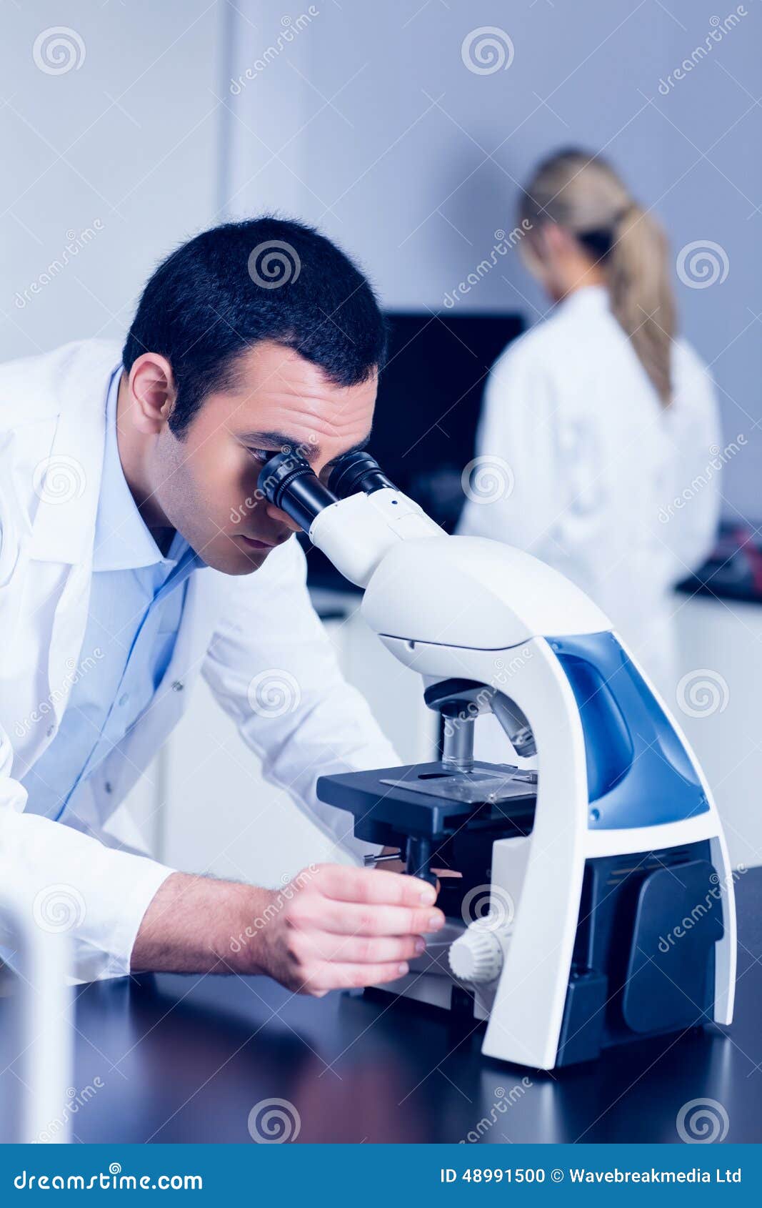 Science Student Looking through Microscope in the Lab Stock Photo ...
