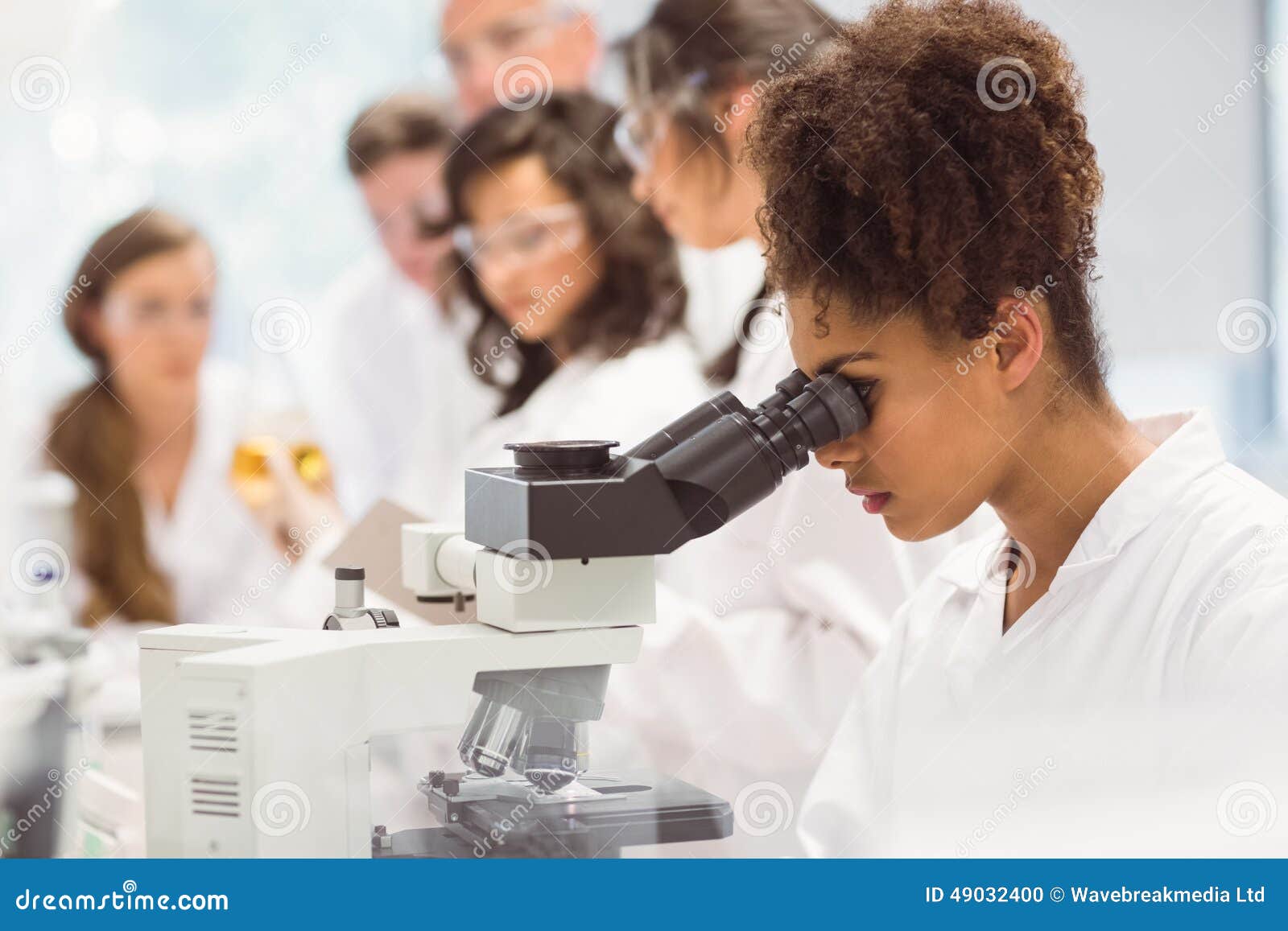 Science Student Looking through Microscope in the Lab Stock Photo ...