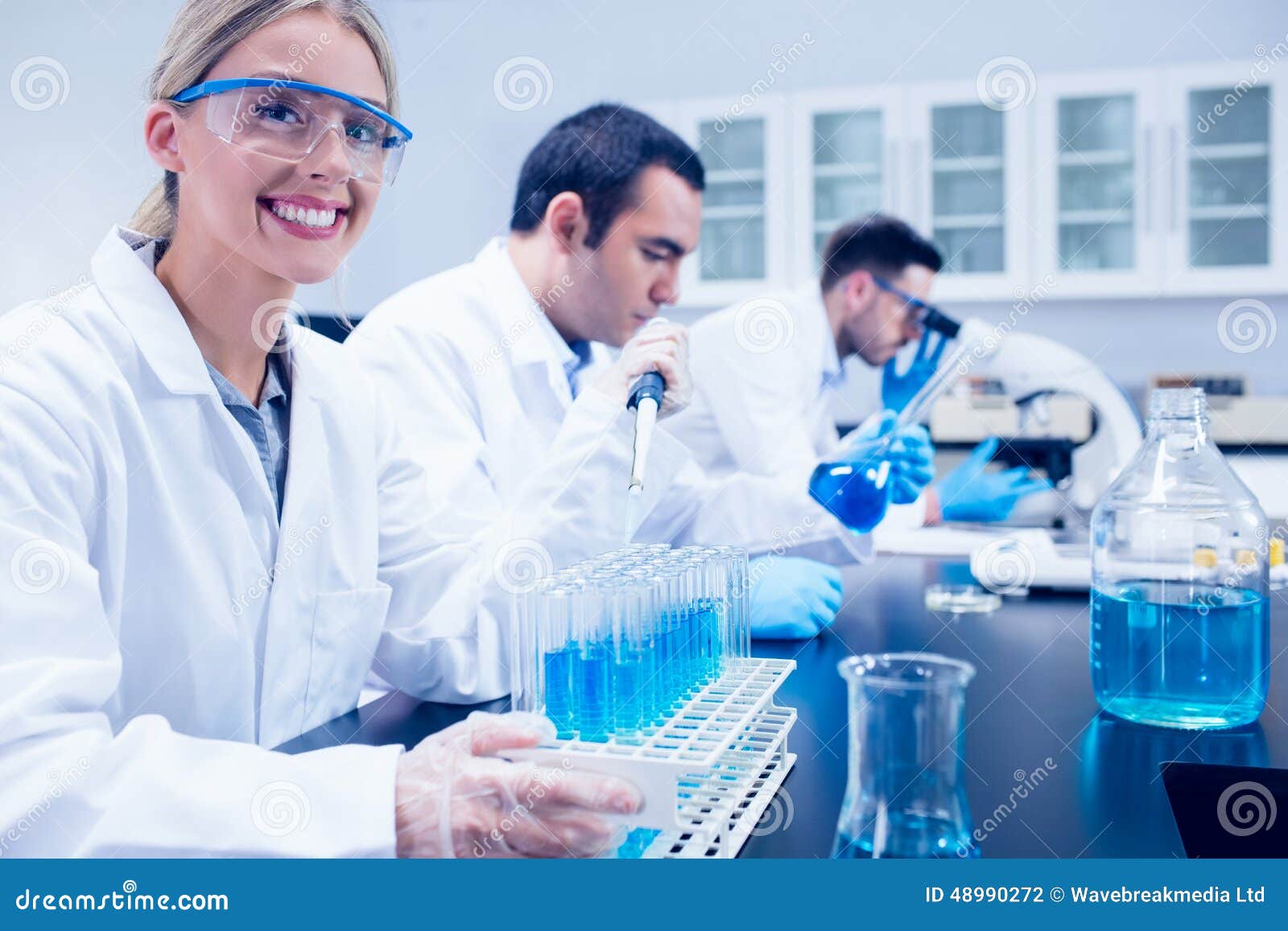 Science Student Using Pipette in the Lab To Fill Test Tubes Stock Photo ...