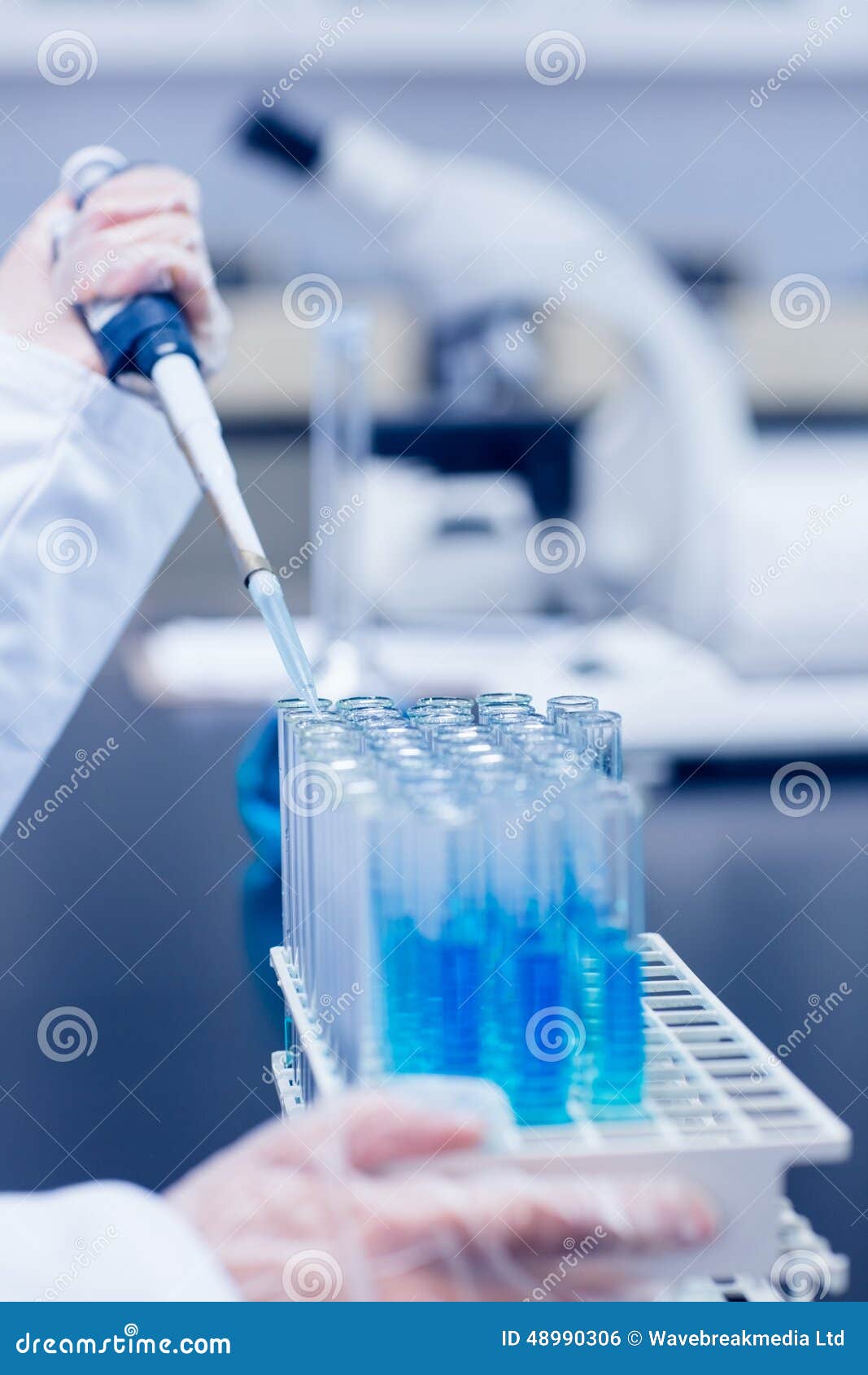 Science Student Using Pipette in the Lab To Fill Test Tubes Stock Photo ...