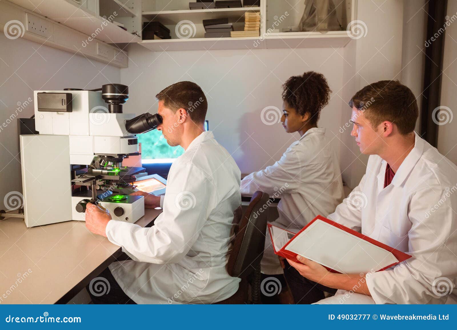 Science Students Looking through Microscope Stock Image - Image of ...