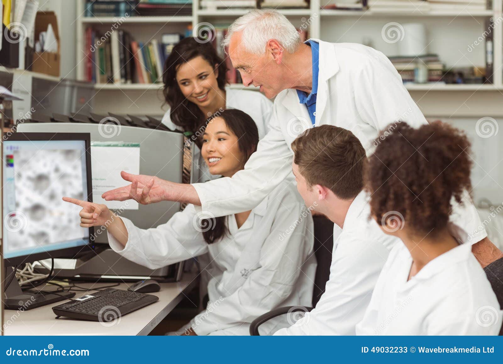 Science Students Looking at Microscopic Image on Computer with Lecturer ...