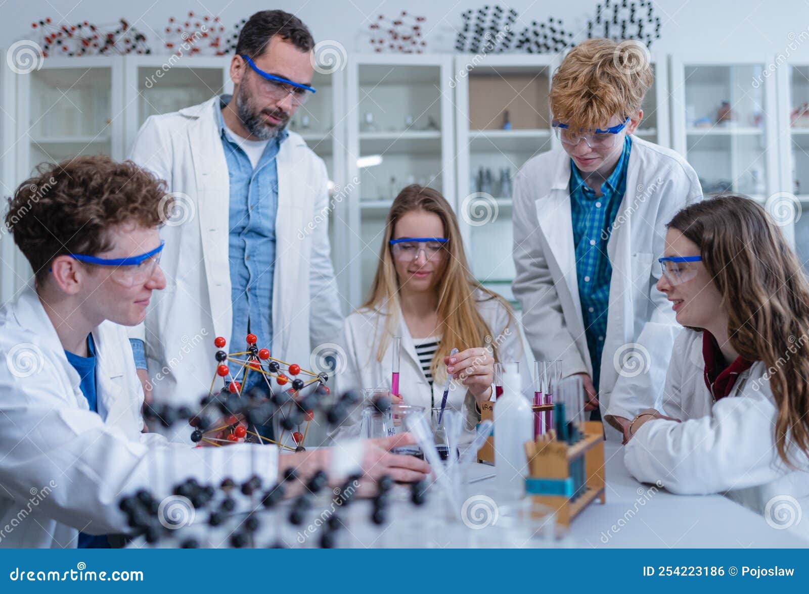 Science Students with Teacher Doing Chemical Reaction Experiment in the ...