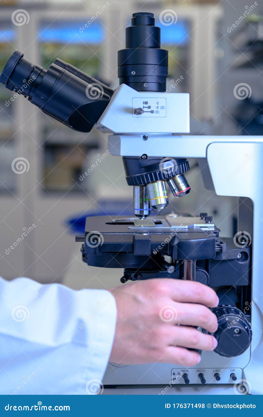 Scientific Handling a Light Microscope Examines a Laboratory Sample for ...