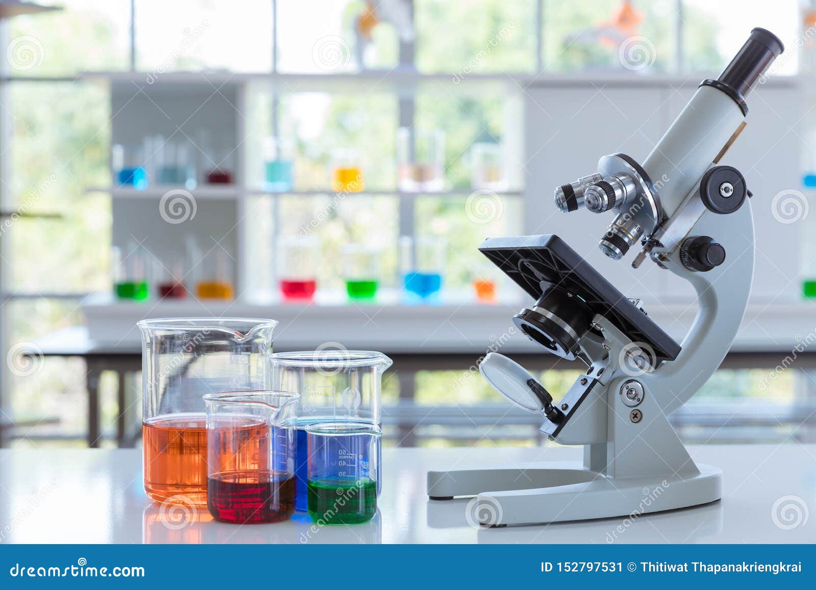 The Scientific Microscope with the Scientific Glassware on the White ...