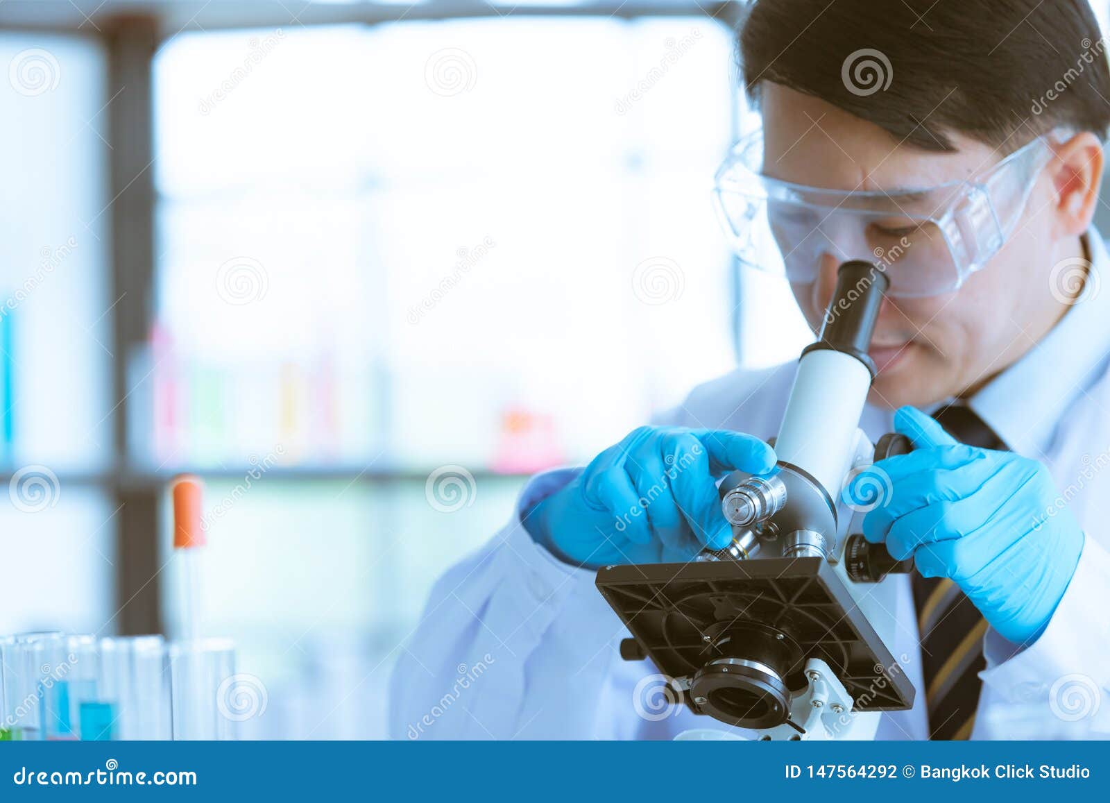 Scientist Adjusting Microscope for Experiment Stock Photo - Image of ...