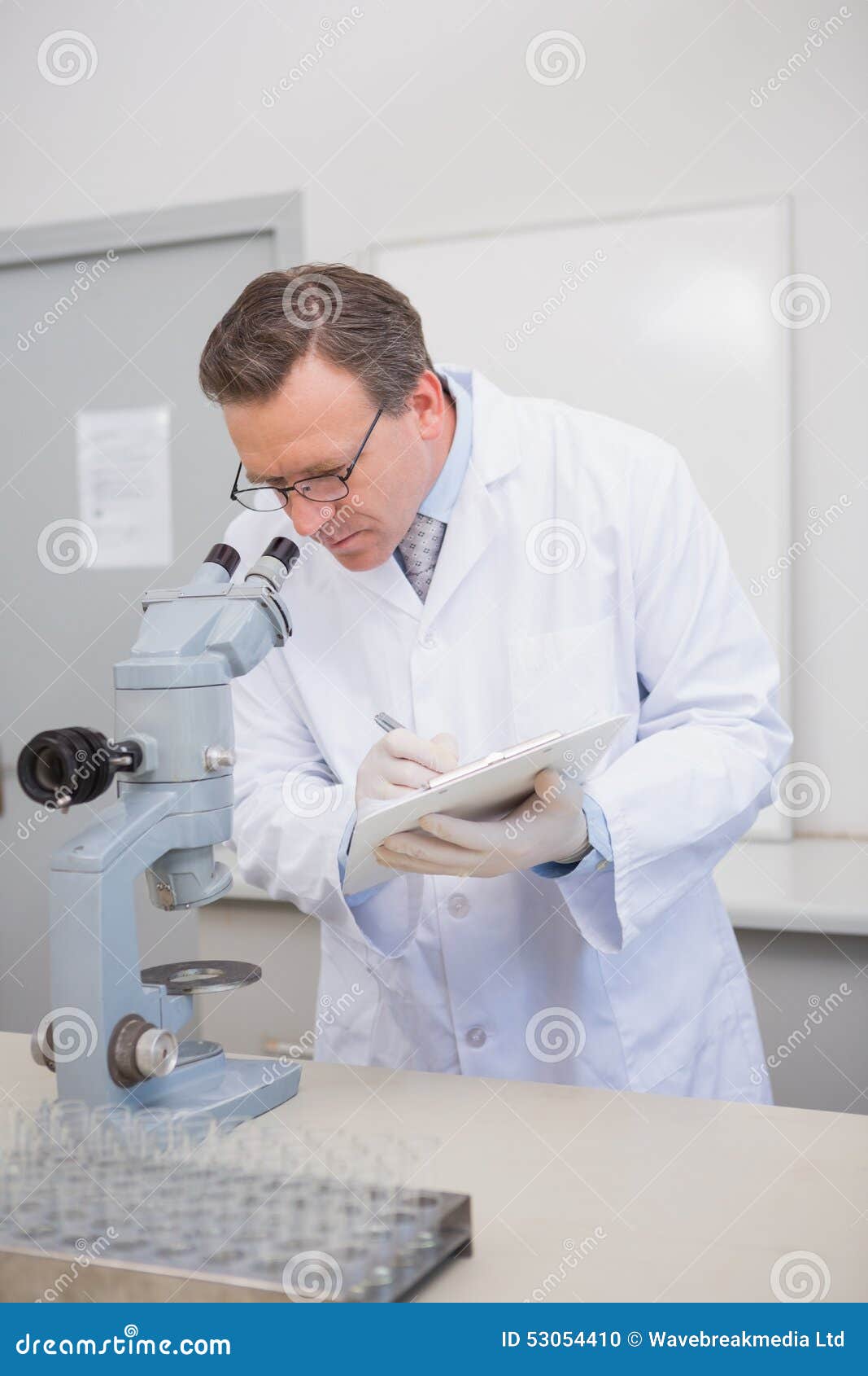Concentrated Male Scientist Writing On A Clipboard Royalty-Free Stock ...