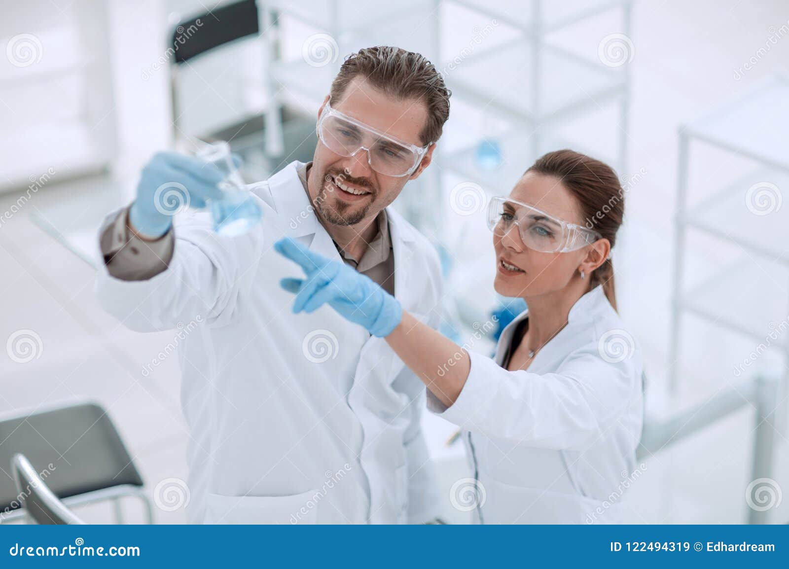 Scientist and Assistant Look at the Liquid in the Flask Stock Image ...