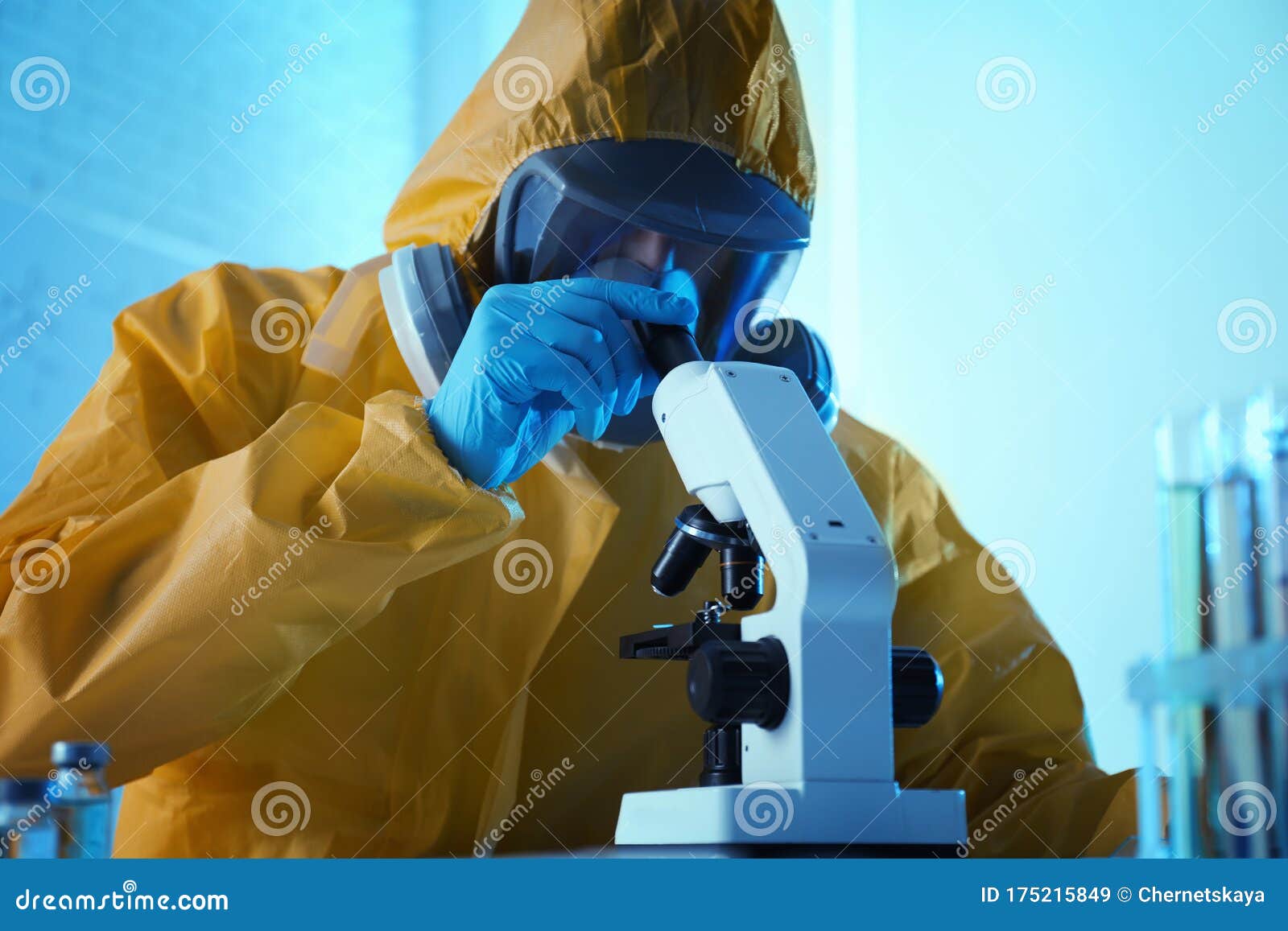Scientist in Chemical Protective Suit Using Microscope. Virus Research ...