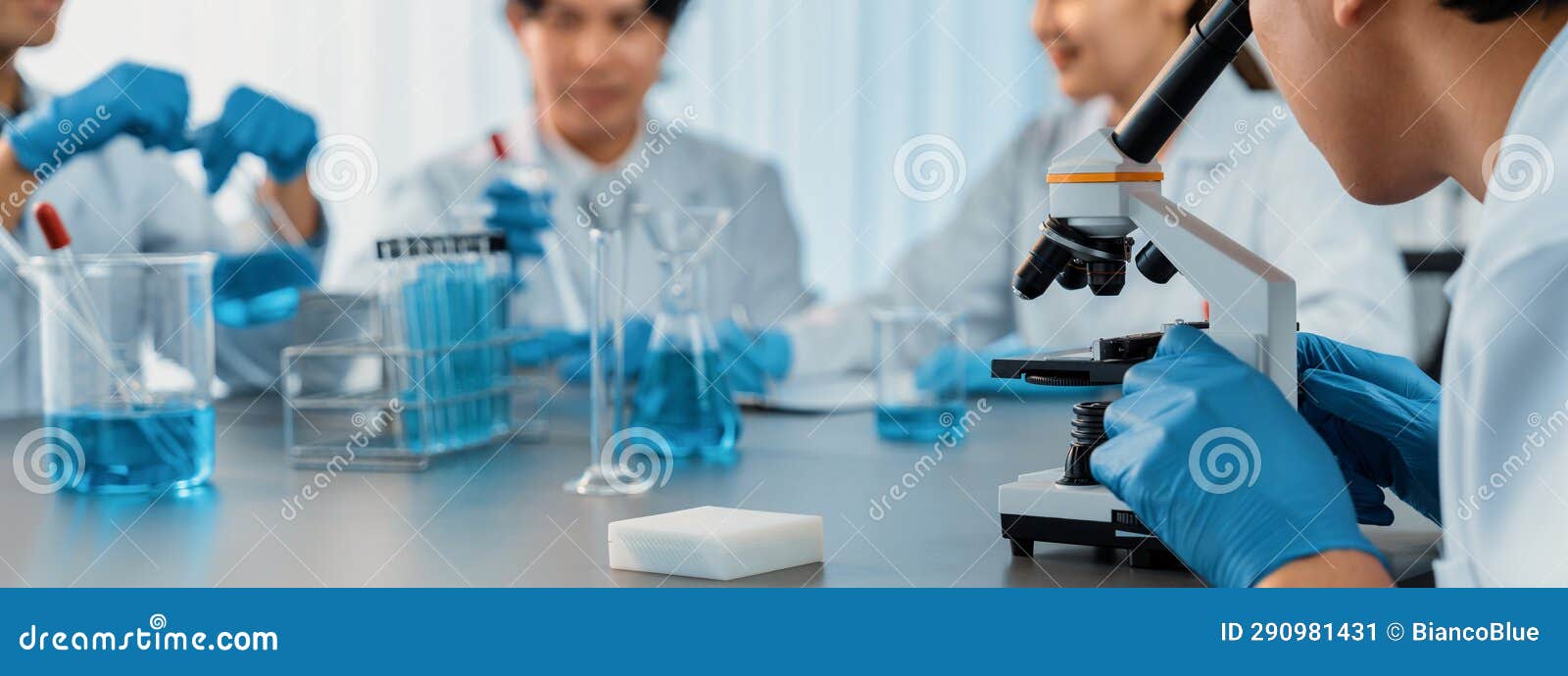 Scientist Conduct Chemical Experiment Using Microscope in Medical Lab ...