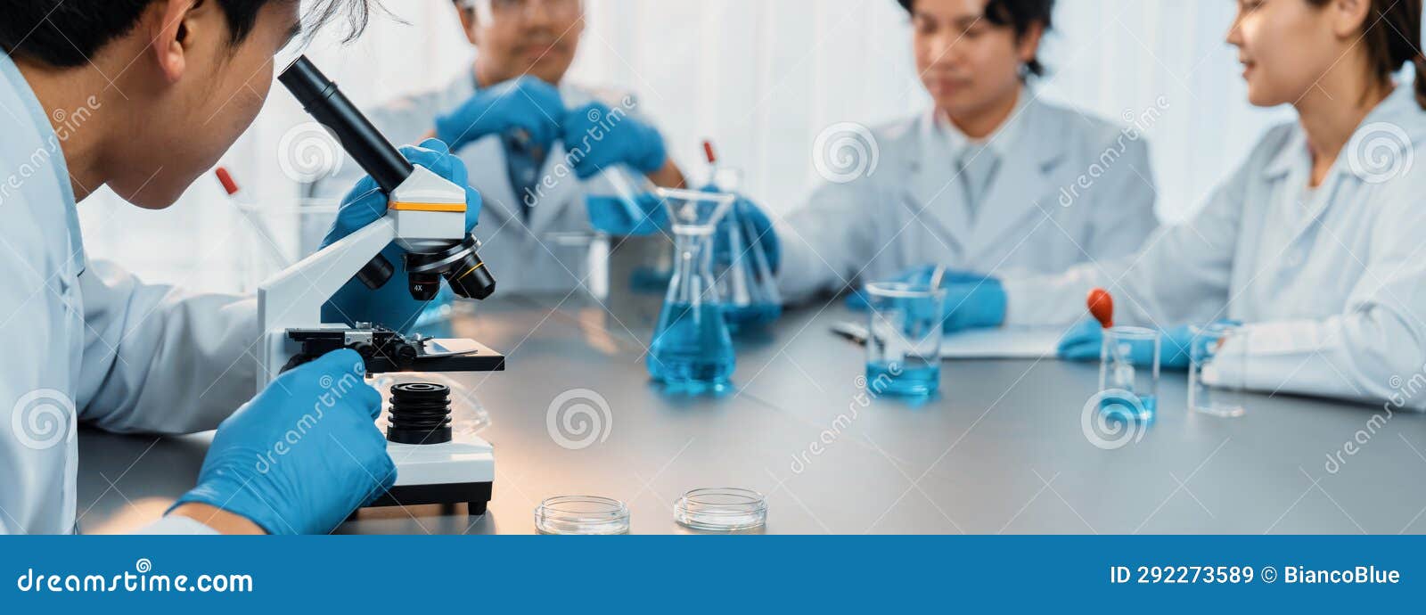 Scientist Conduct Chemical Experiment Using Microscope in Medical Lab ...