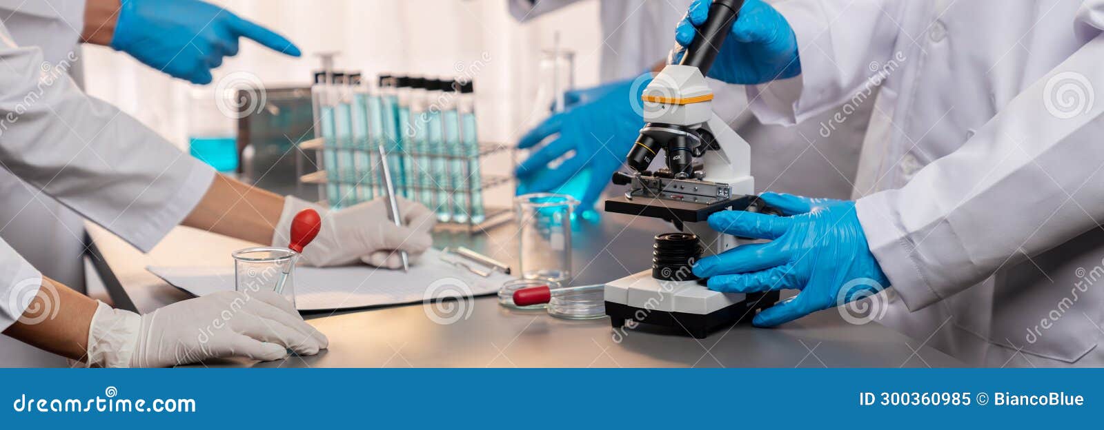 Scientist Conduct Chemical Experiment Using Microscope in Medical Lab ...