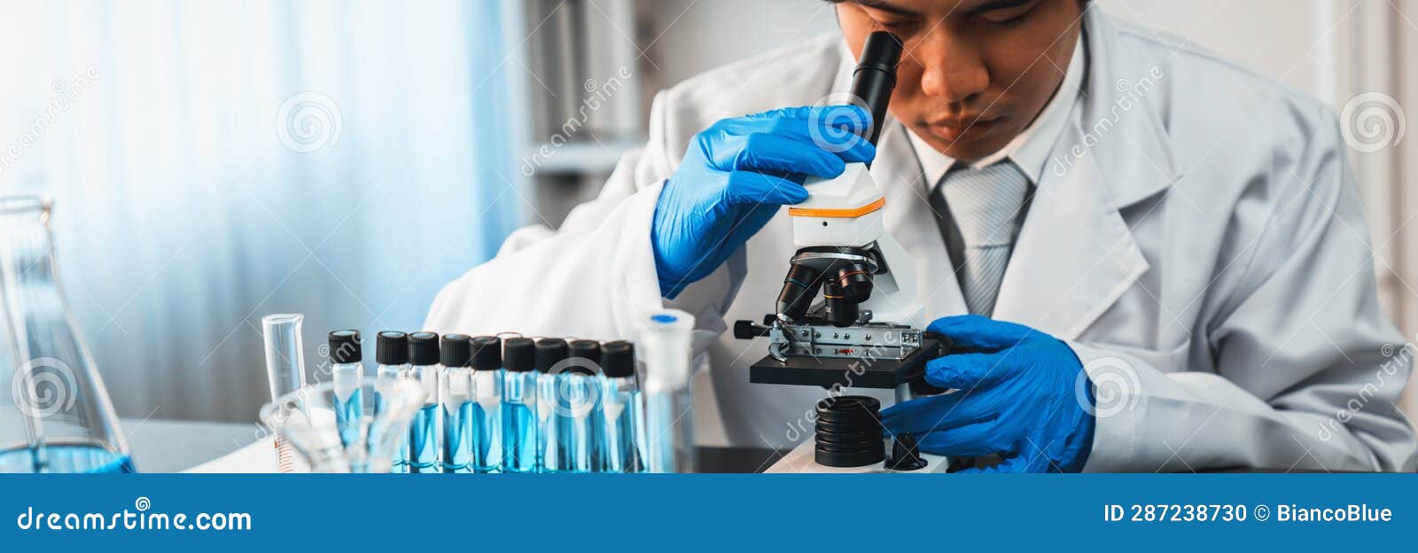Scientist Conduct Chemical Experiment Using Microscope in Medical Lab ...