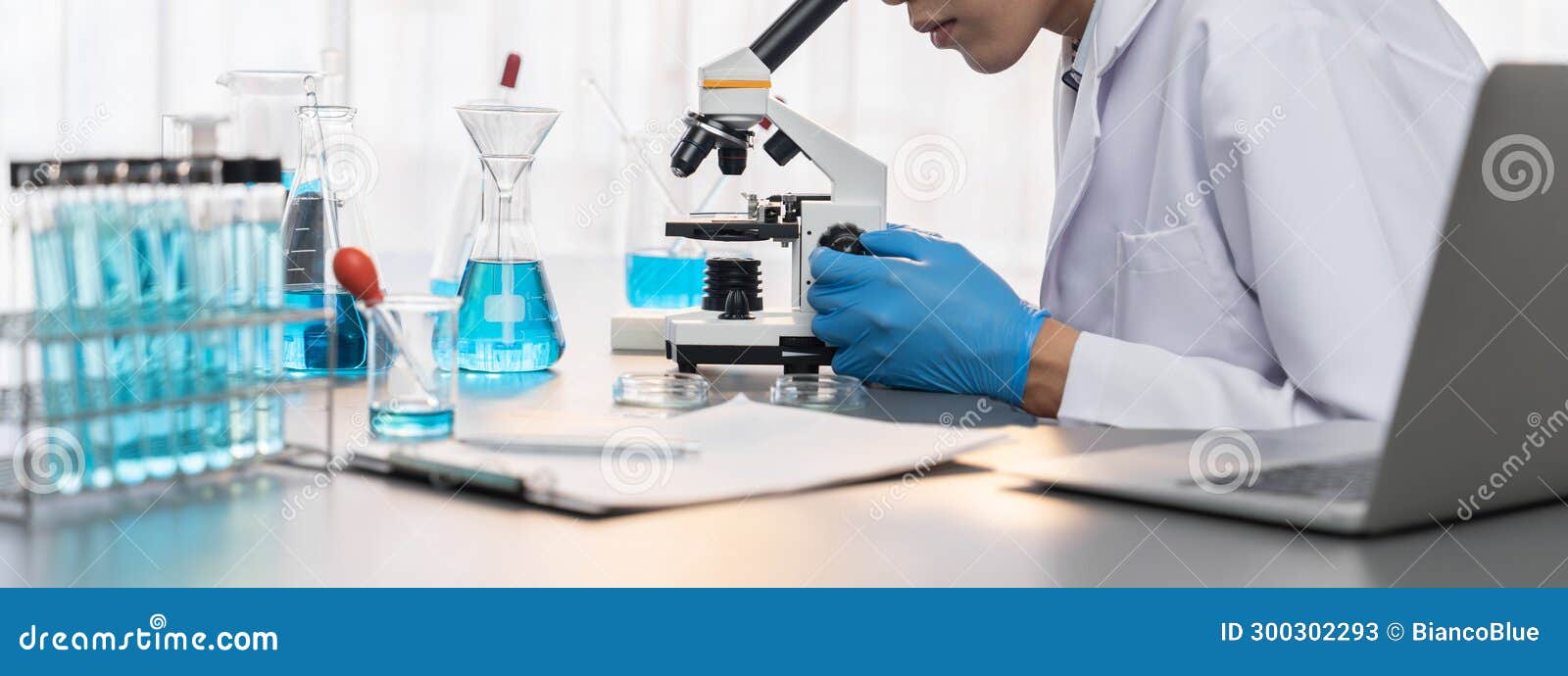 Scientist Conduct Chemical Experiment Using Microscope in Medical Lab ...