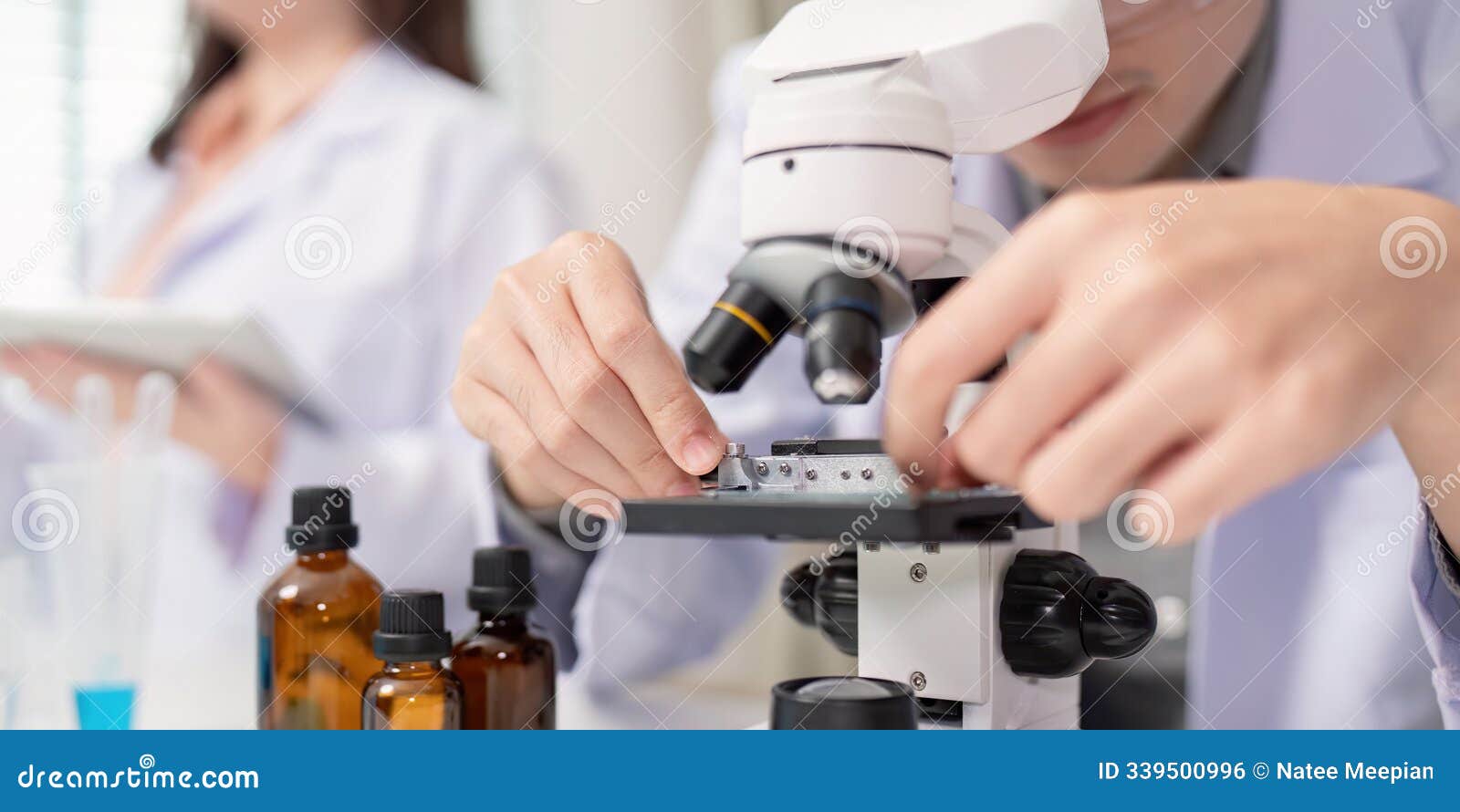 Scientist Conducting Microbial Analysis with Microscope for Research ...
