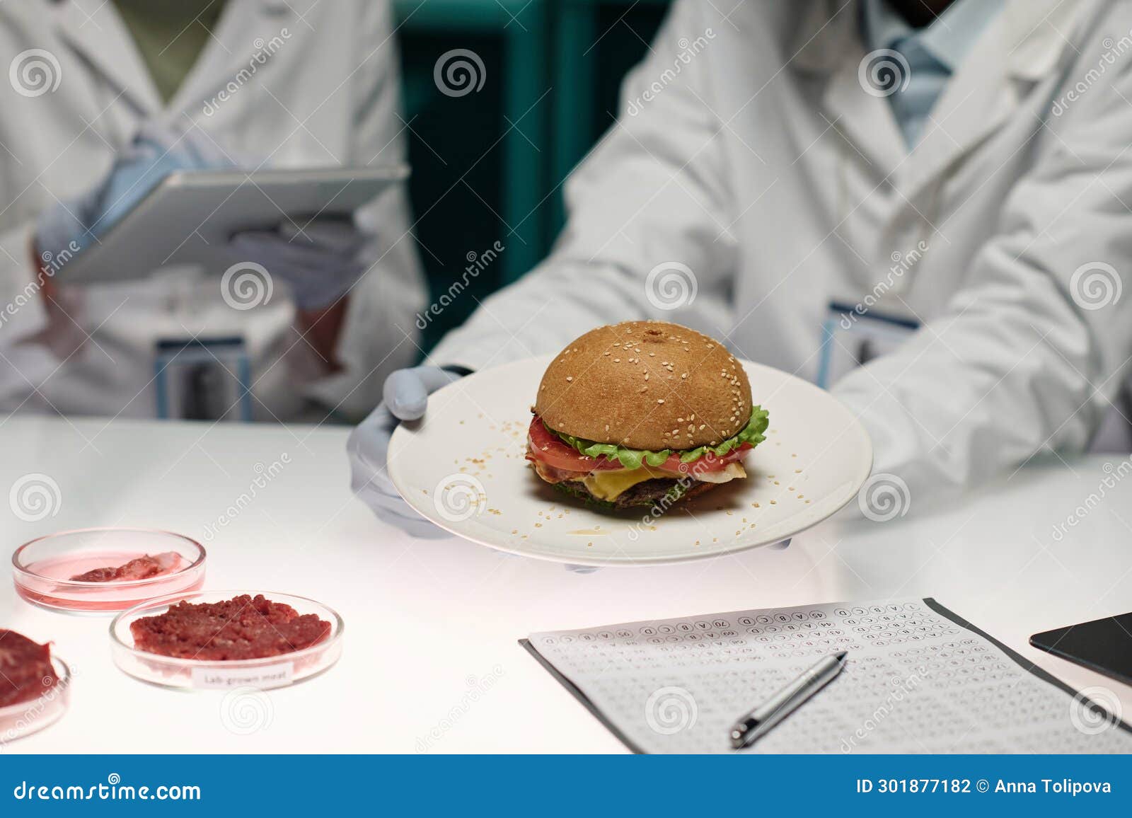 Scientist Demonstrating Lab-Grown Meat Burger Sample Stock Photo ...