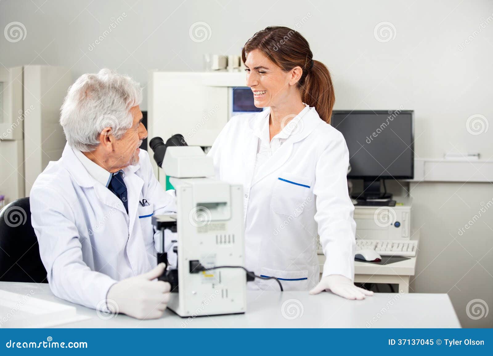 Scientist Discussing with Colleague while Using Stock Image - Image of ...