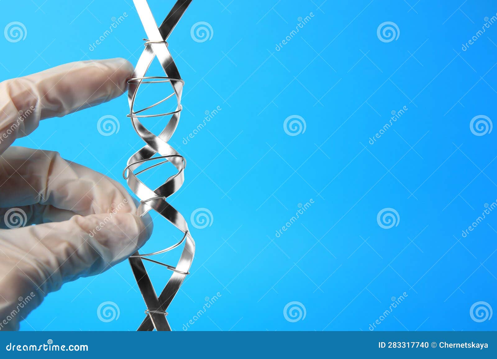 Scientist with DNA Molecular Chain Model Made of Metal on Blue ...