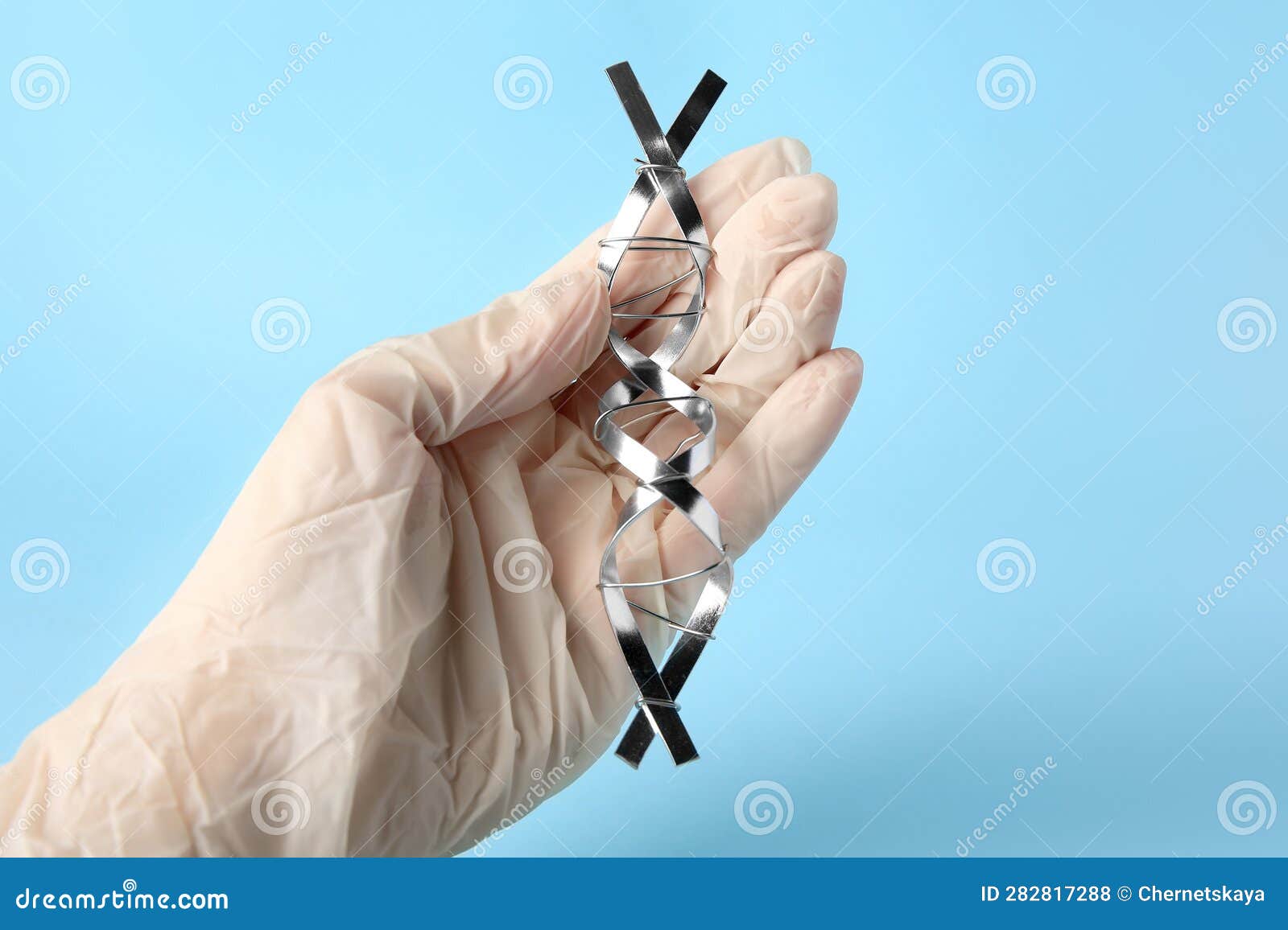Scientist with DNA Molecular Chain Model Made of Metal on Light Blue ...