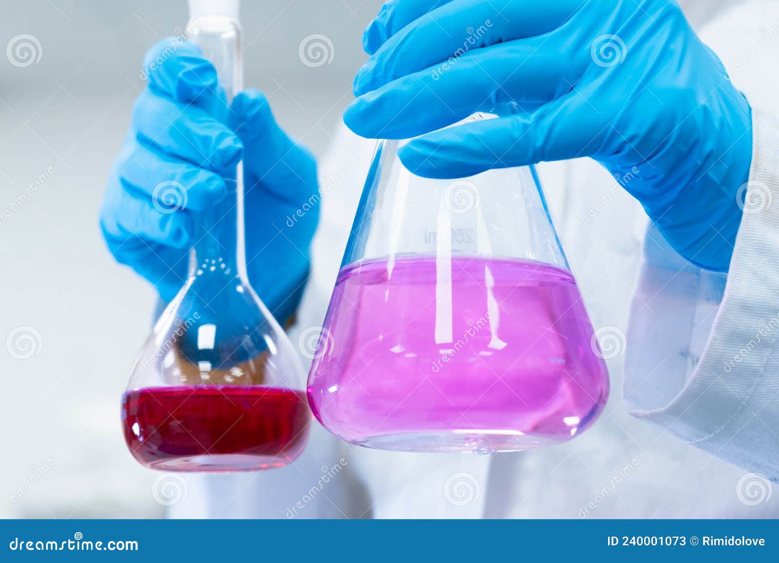Scientist Doing Experiments with Bright Solutions in the Flasks at the ...