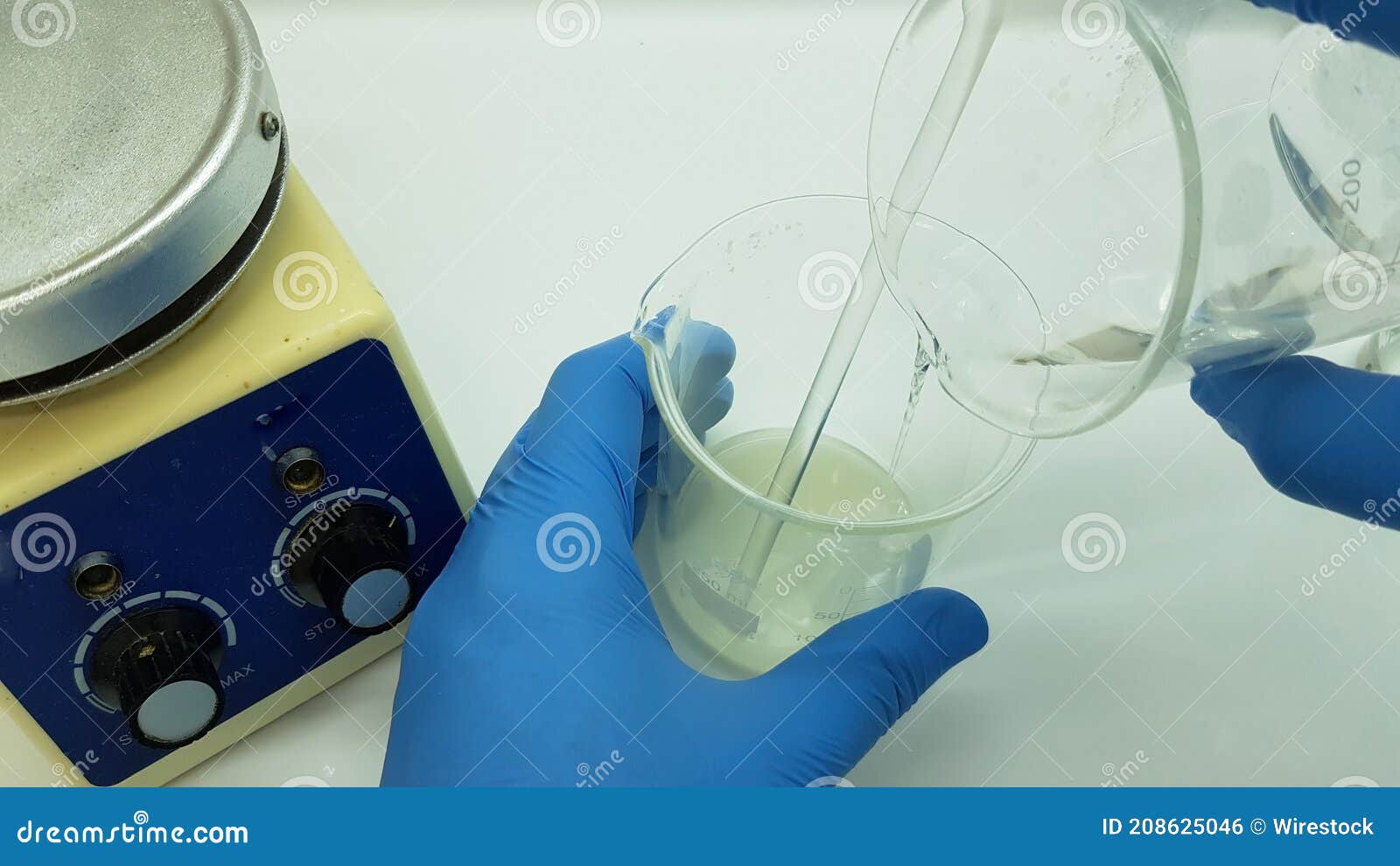 Scientist Doing an Investigation through a Beaker in the Laboratory ...