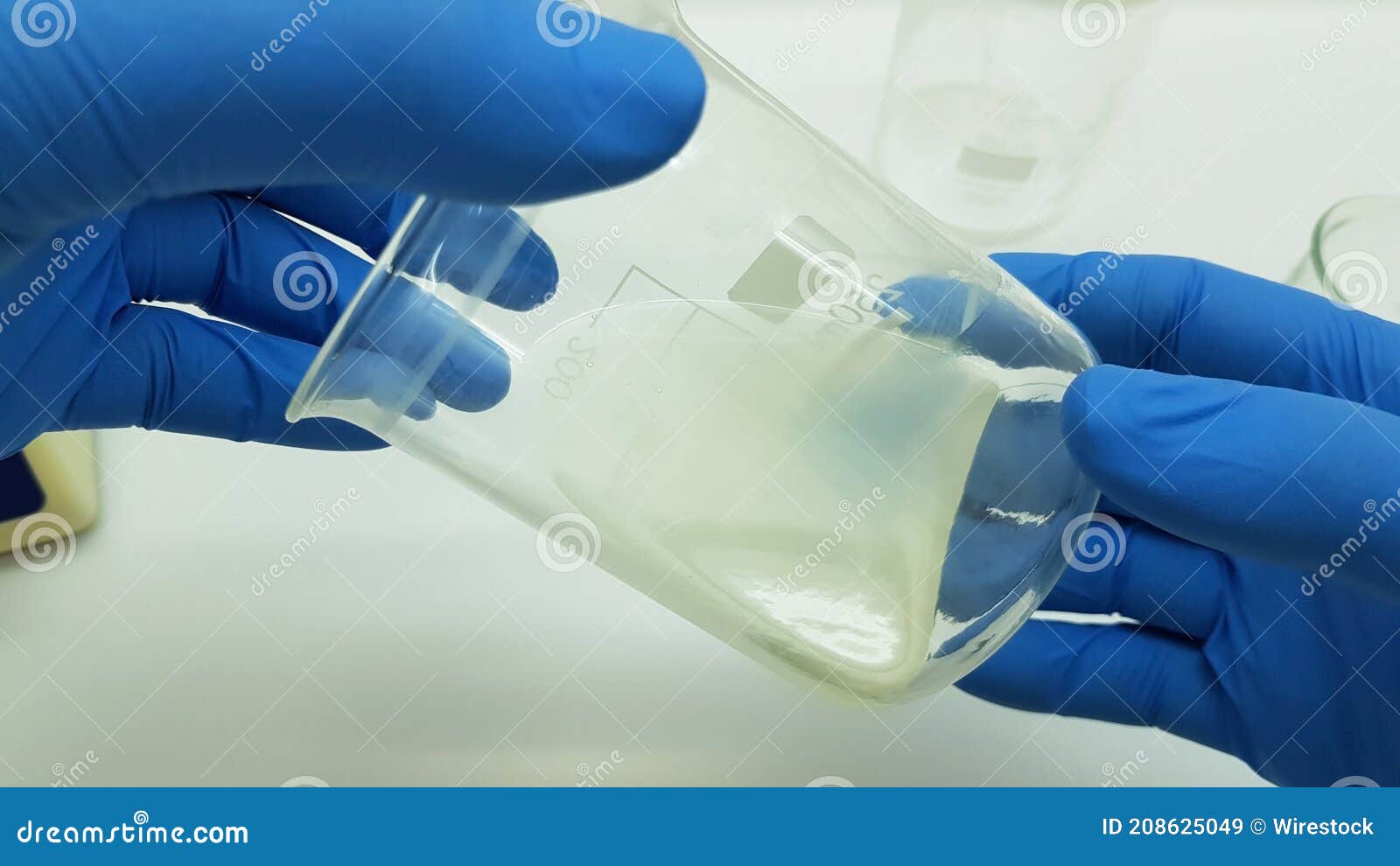 Scientist Doing an Investigation through a Beaker in the Laboratory ...