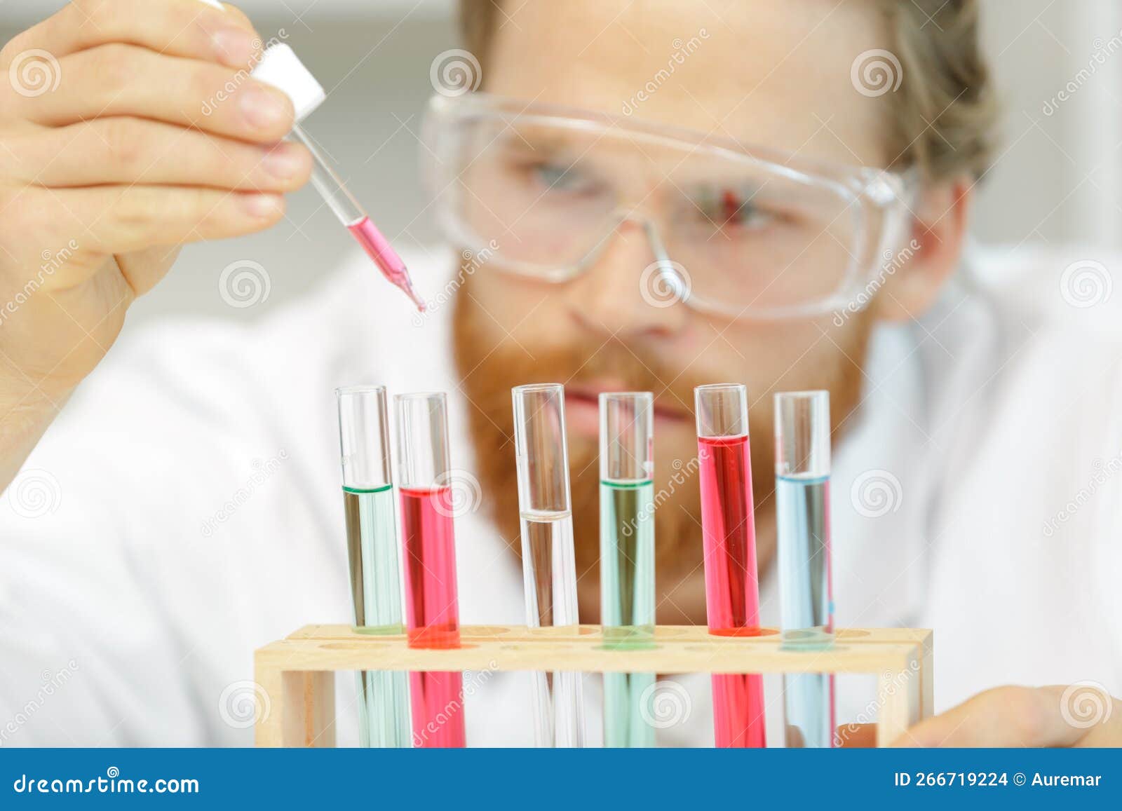 Scientist Dripping Liquid from Pipette into Test Tube Stock Photo ...