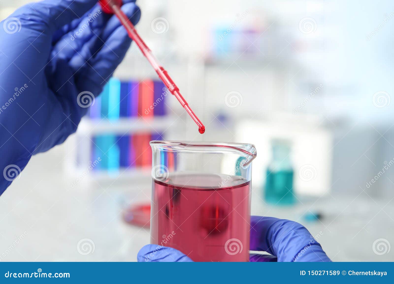 Scientist Dripping Reagent into Beaker with Sample in Chemistry ...