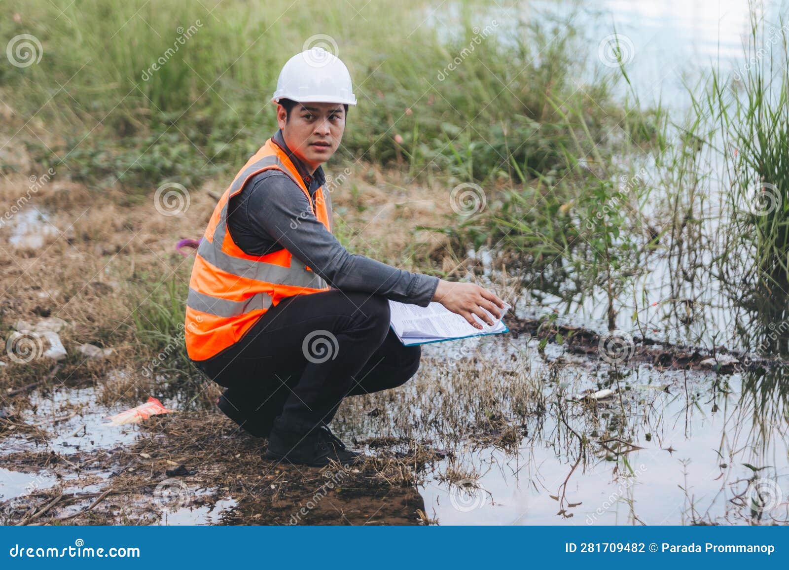 Scientist Ecologist Taking a Water Sample and Reading Ph Value at River ...