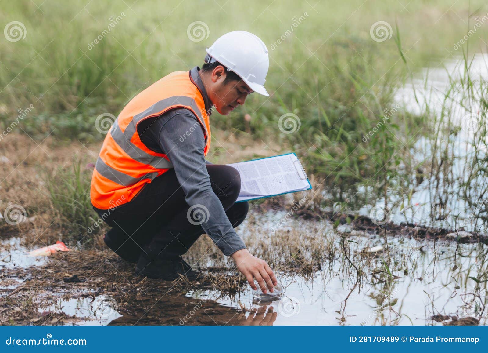 Scientist Ecologist Taking a Water Sample and Reading Ph Value at River ...