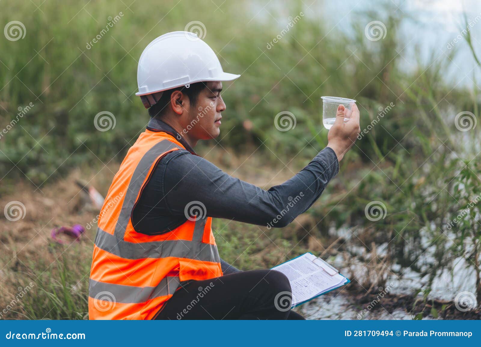 Scientist Ecologist Taking a Water Sample and Reading Ph Value at River ...