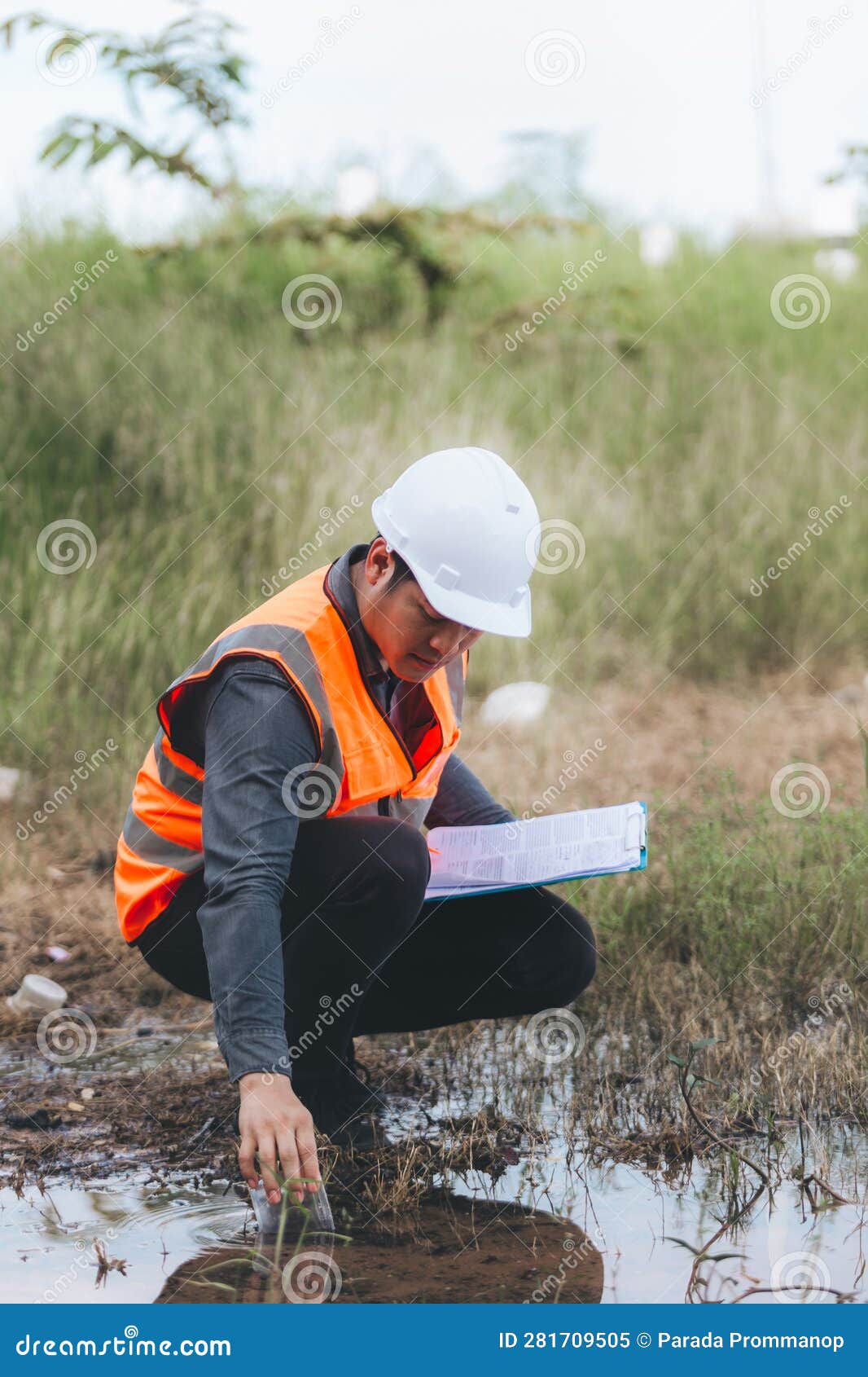 Scientist Ecologist Taking a Water Sample and Reading Ph Value at River ...