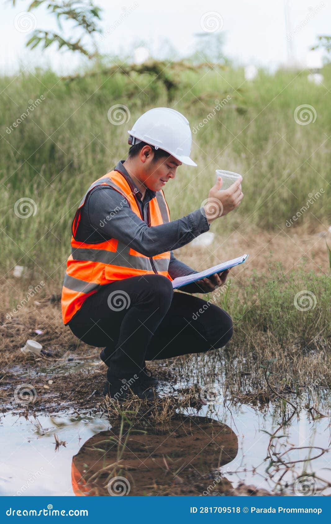 Scientist Ecologist Taking a Water Sample and Reading Ph Value at River ...