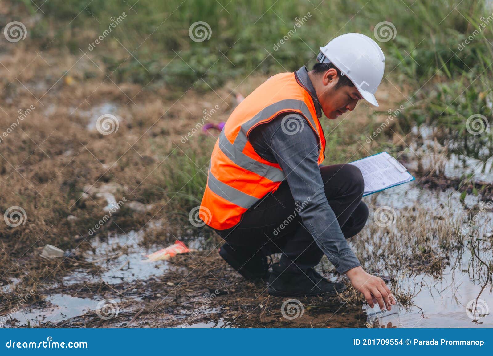 Scientist Ecologist Taking a Water Sample and Reading Ph Value at River ...