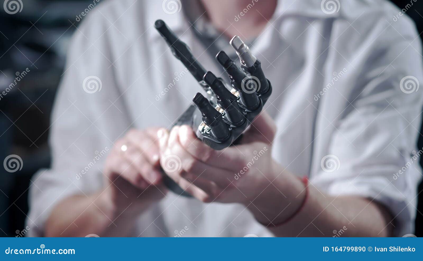 A Scientist Engineer is Testing an Electronic Bionic Prosthetic Arm. he ...