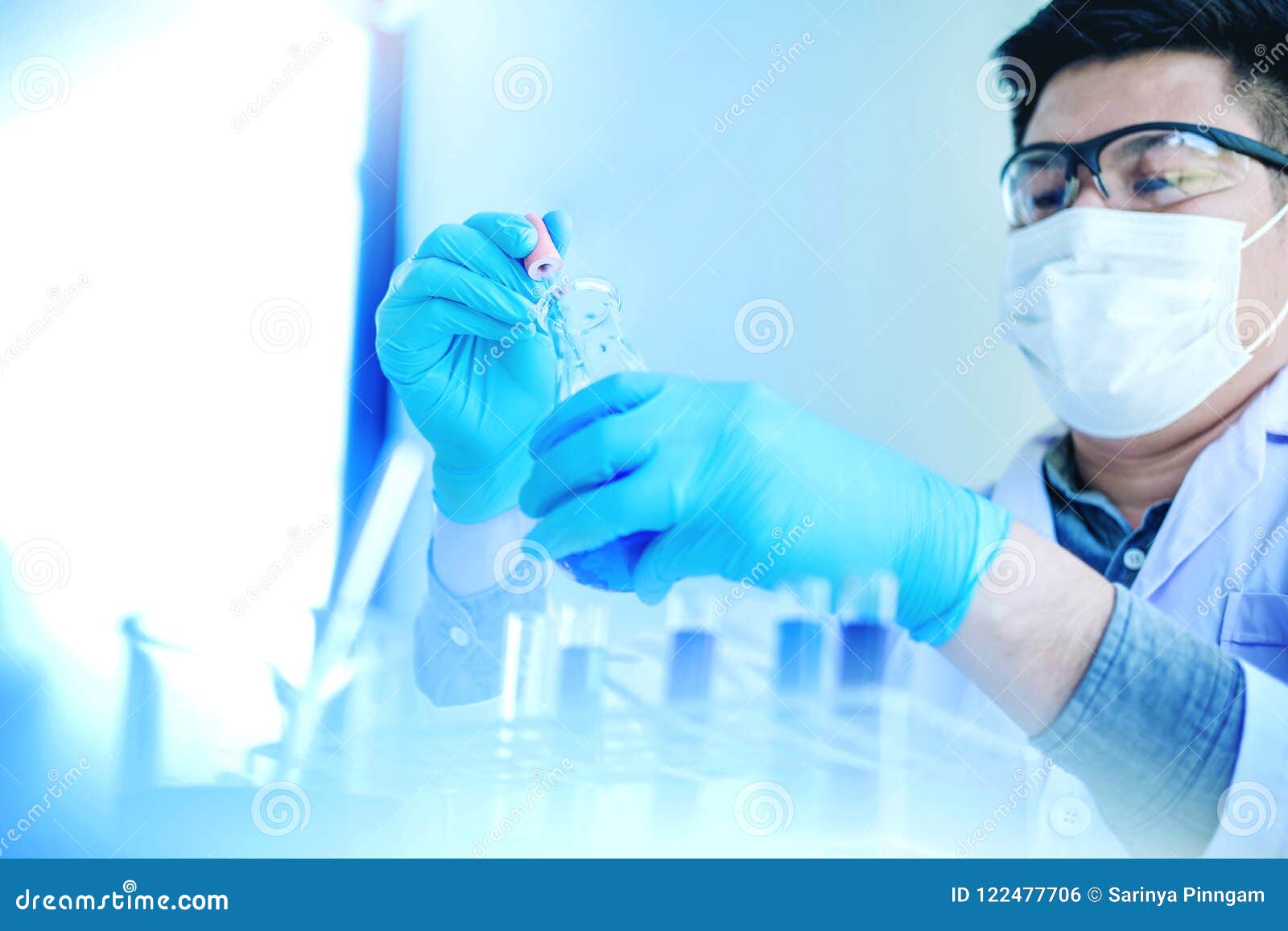 Scientist with Equipment Holding Tools during Scientific Experiment ...