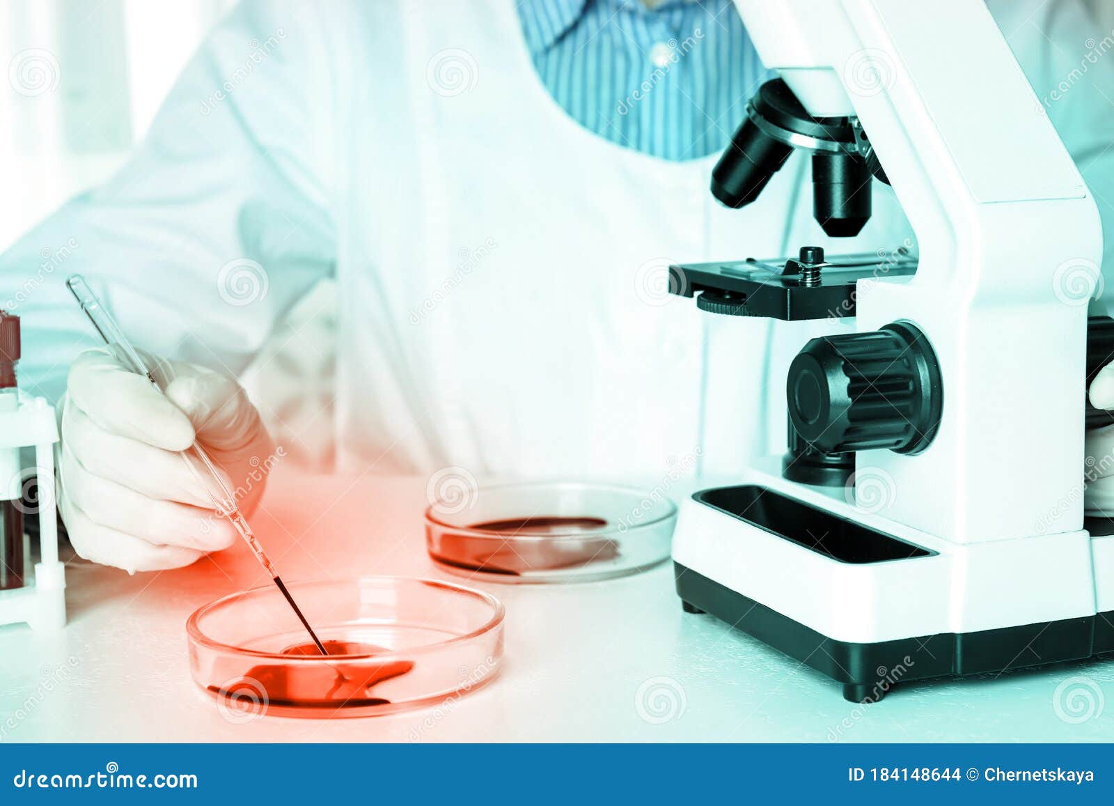 Scientist Examining Blood Sample with Microscope. Laboratory Analysis ...