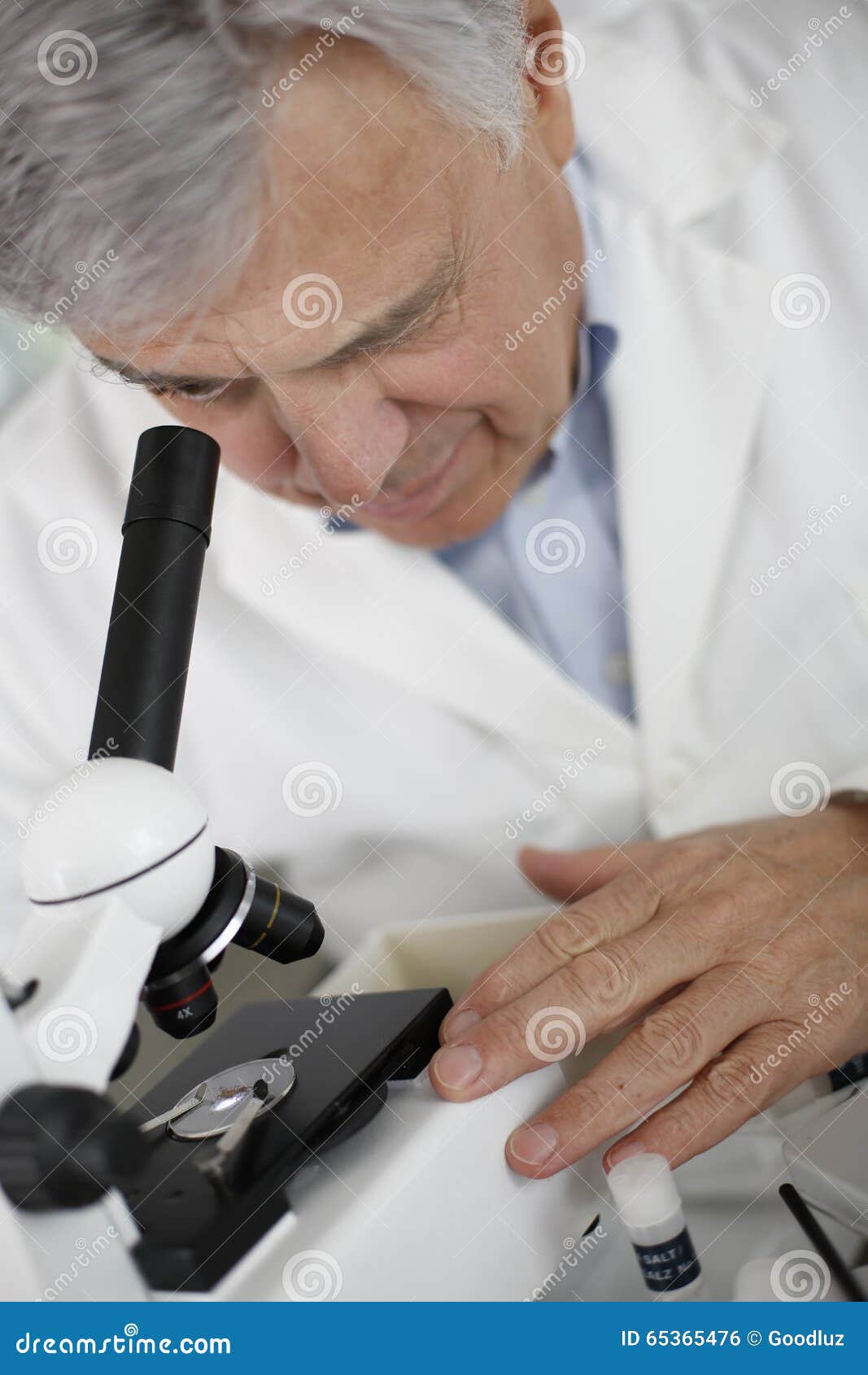 Scientist Examining Blood Sample through Microscope Stock Photo - Image ...