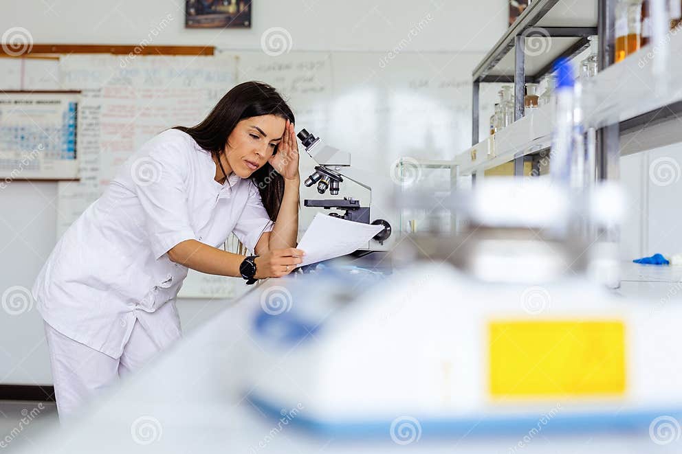 Scientist Examining Data in Lab with Microscope in Sight Stock Image ...