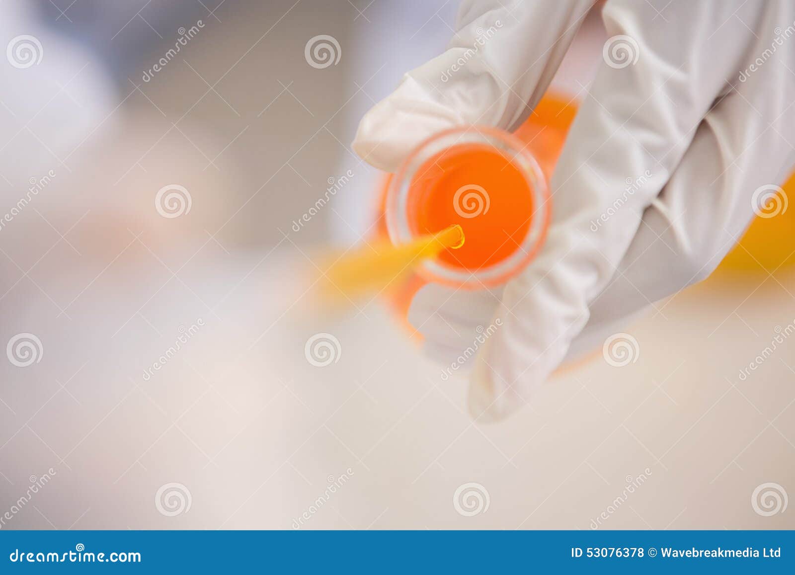 Scientist Examining Orange Fluid Stock Photo - Image of medical ...